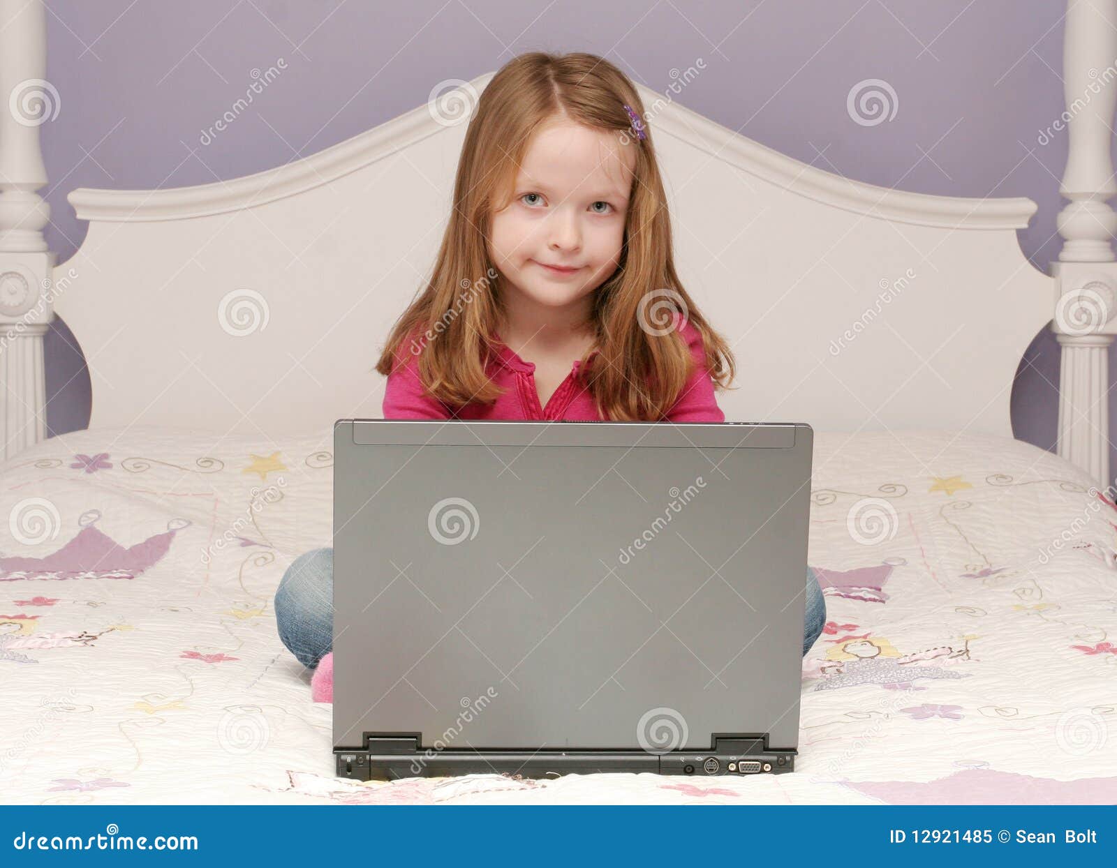Young girl using a laptop stock image. Image of shot - 12921485