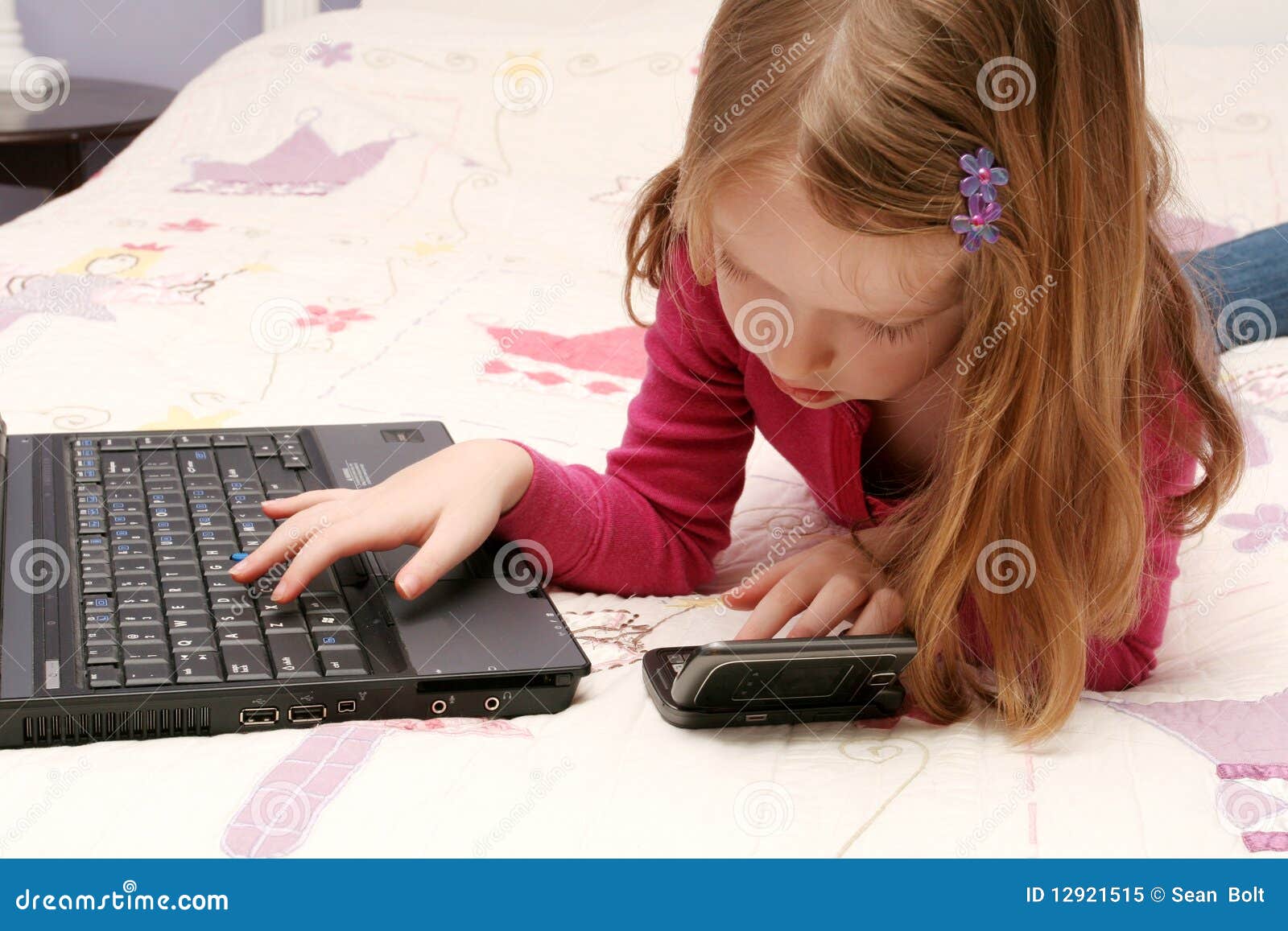 Young girl using a laptop stock image. Image of person - 12921515