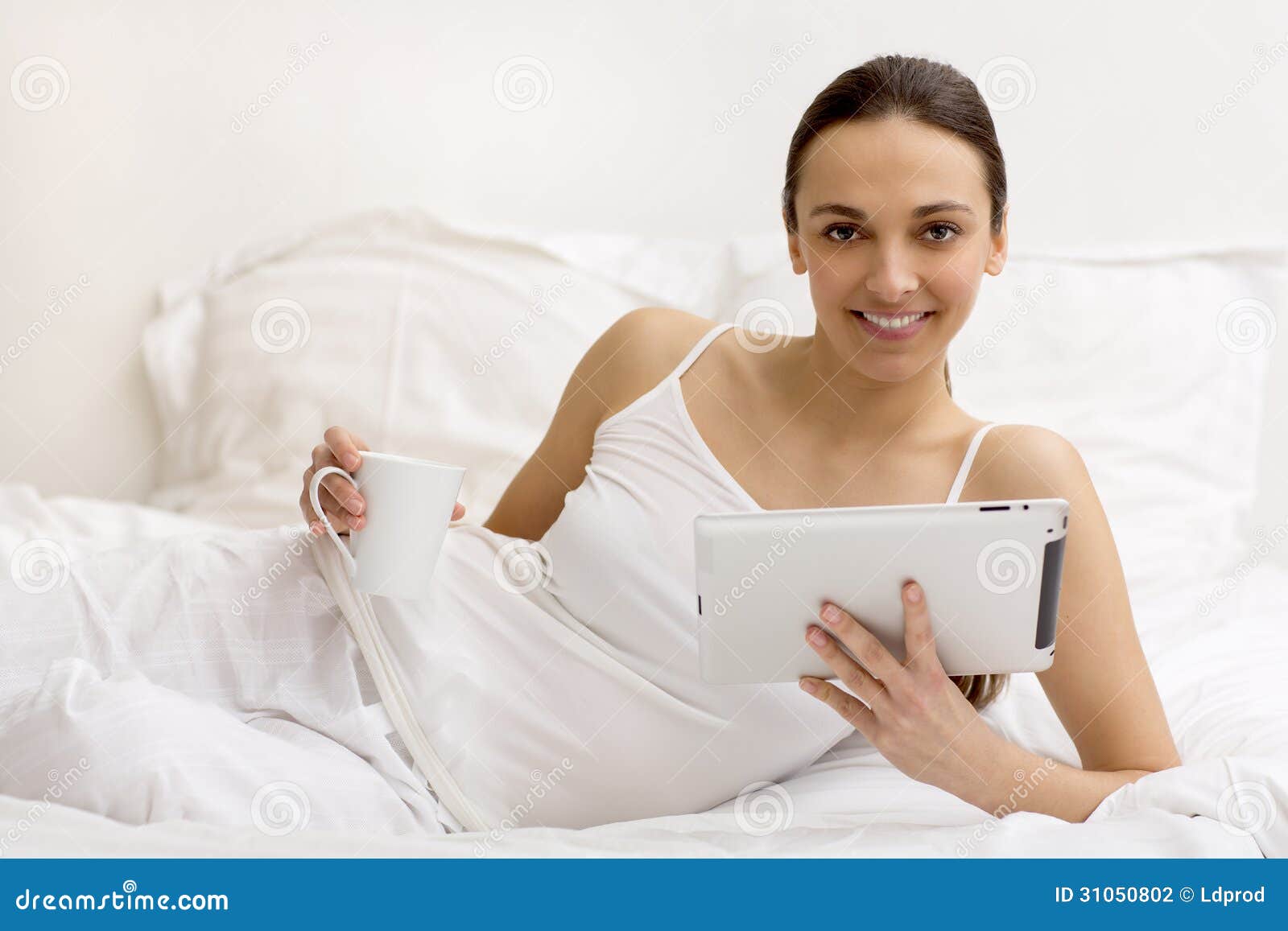 Young Girl Using Tablet on Bed Stock Photo - Image of order, pillows ...
