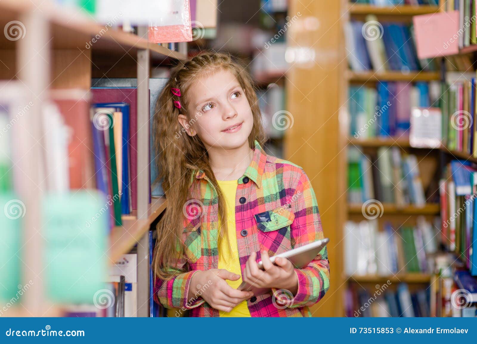 Young Girl Using a Tablet Computer in a Library Stock Image - Image of ...