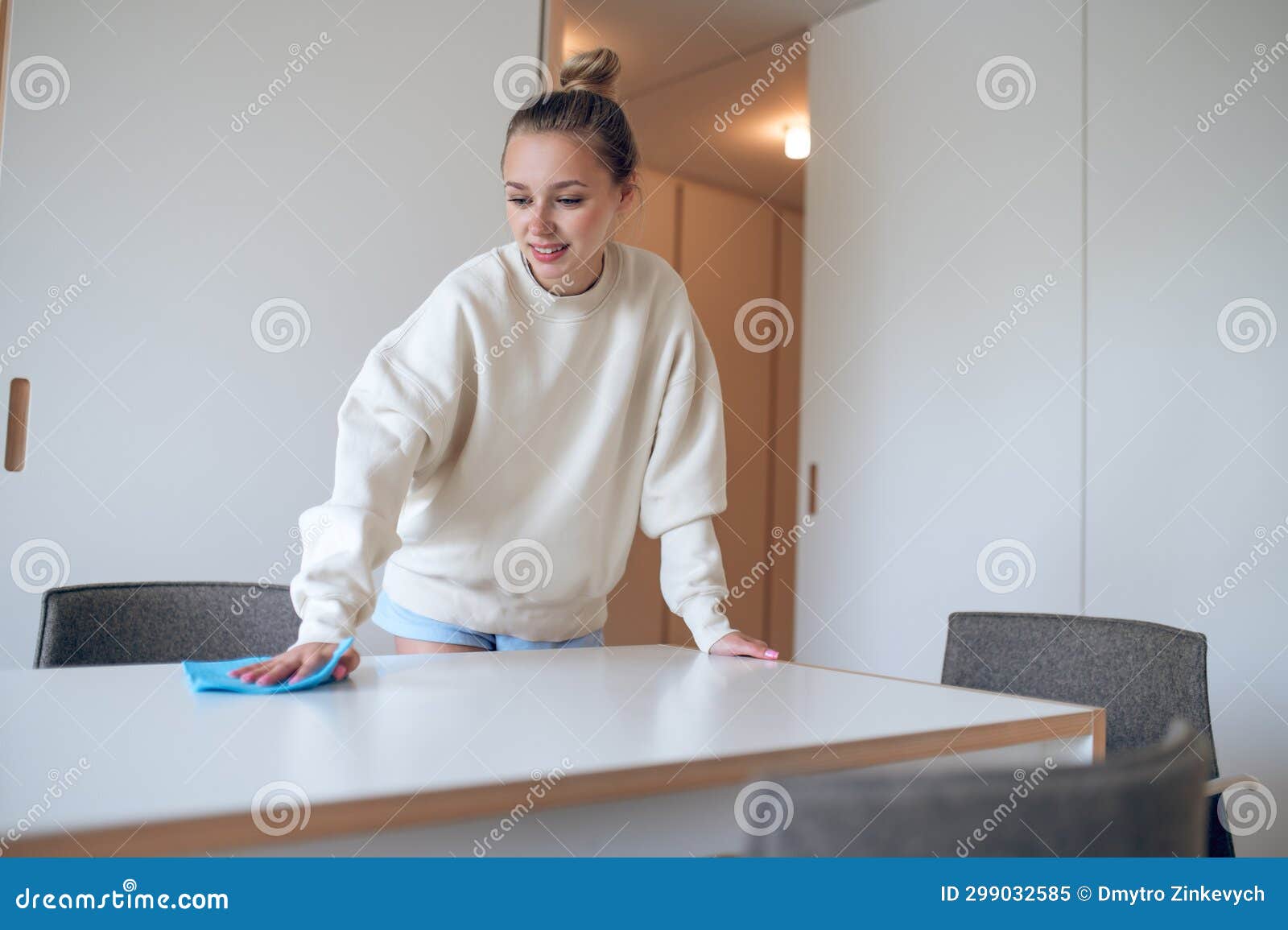 Young Girl in White Doing Cleaning and Looking Involved Stock Image ...