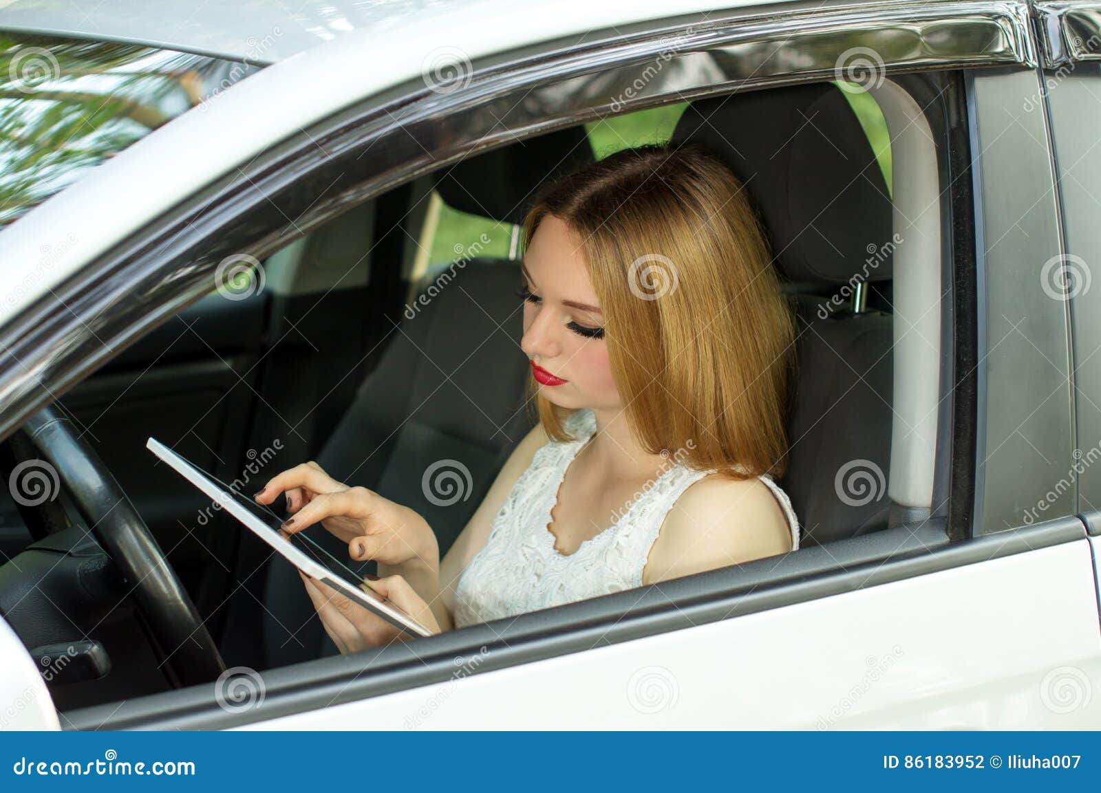 A Young Girl Working while Driving Car Stock Photo - Image of mirror ...