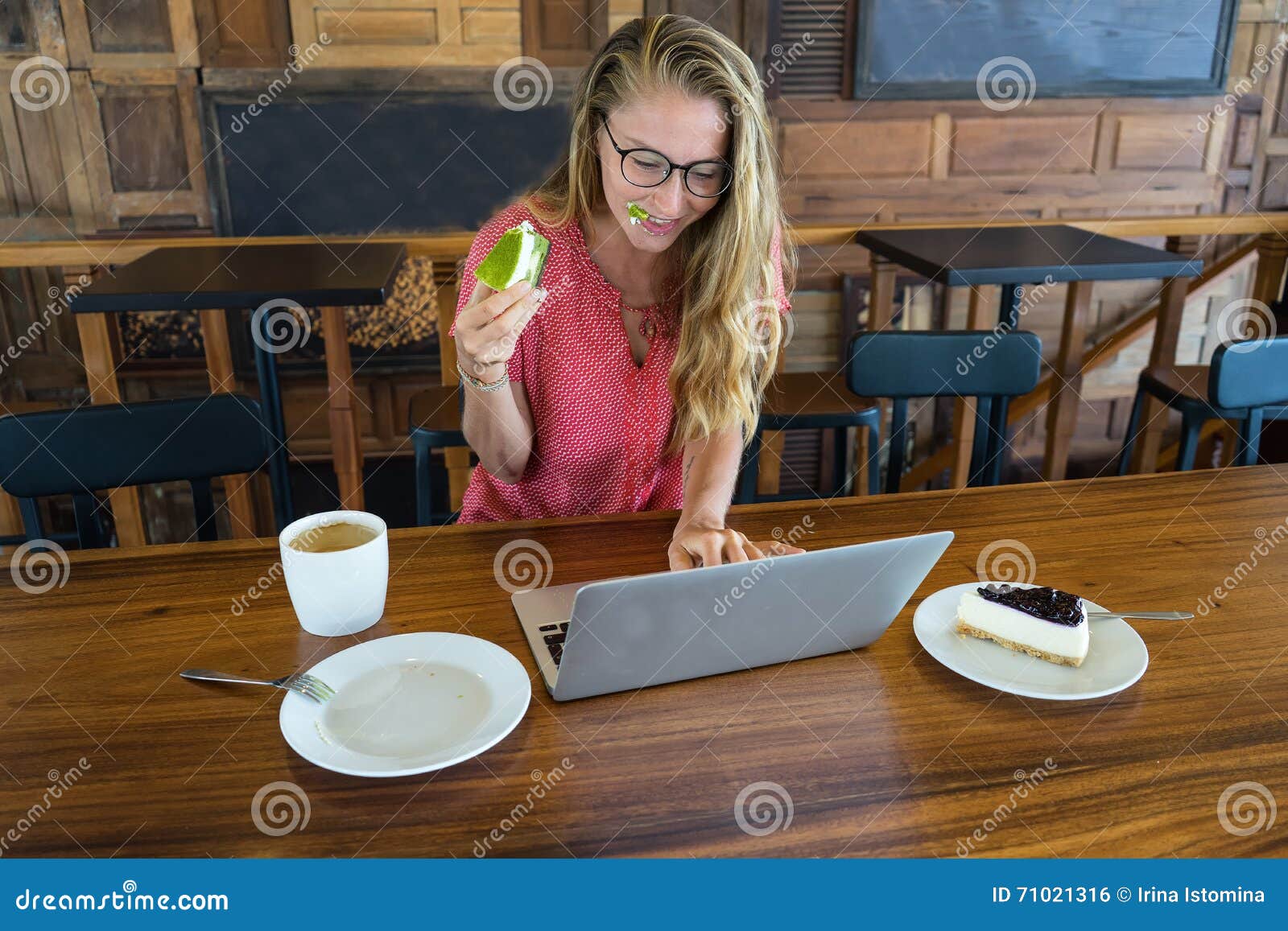 The Young Girl Works at the Computer and Cake, Food at the Computer, a ...