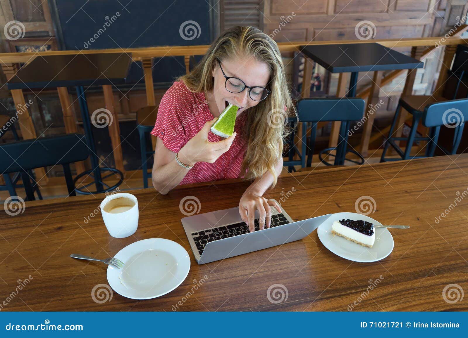 The Young Girl Works at the Computer and Cake, Food at the Computer, a ...