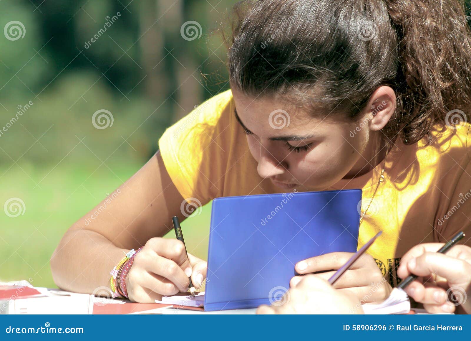 Young Girl Writing at Forest Stock Photo - Image of electronic, casual ...