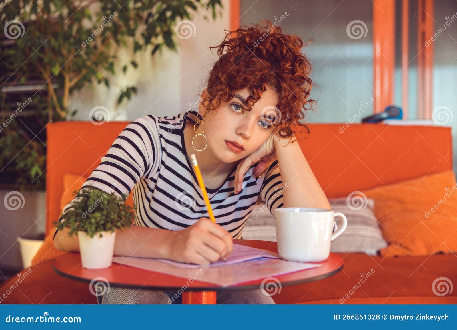 Young Girl Writing Something and Looking Tired and Bored Stock Photo ...