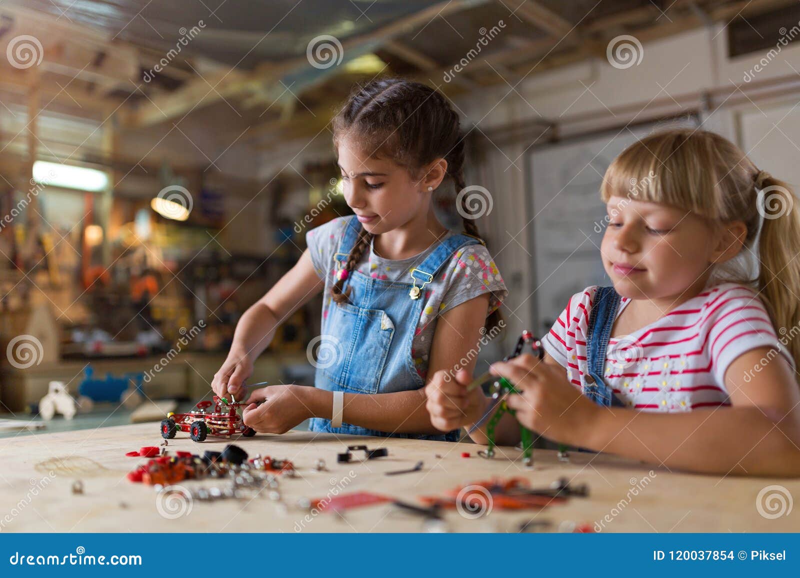 Young Girls Building Toy Construction Machine Stock Photo - Image of ...
