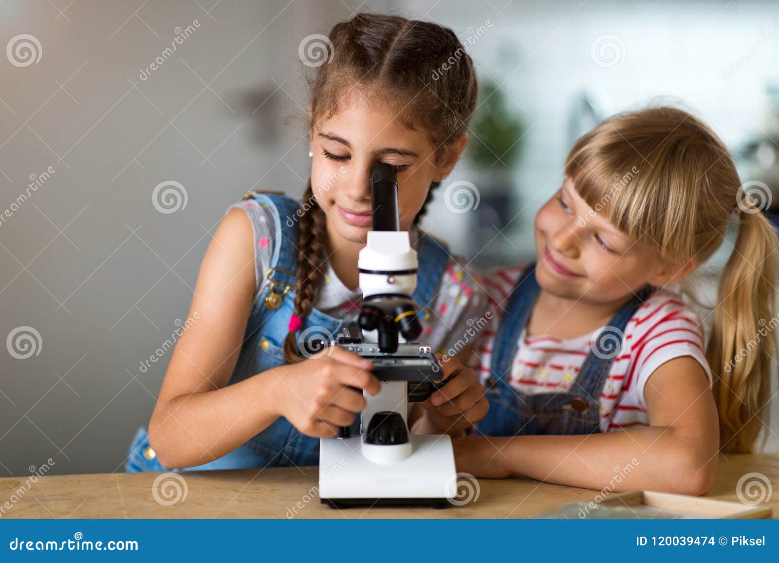 Girls with microscope stock photo. Image of children - 120039474