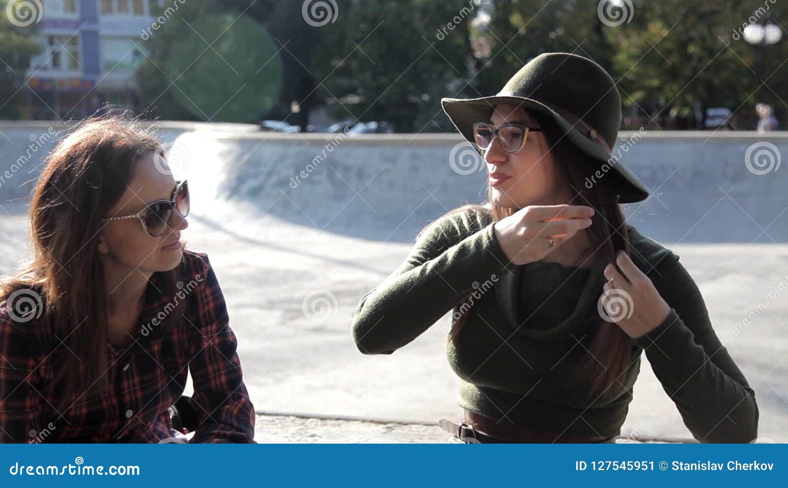 Young Girls Sit in the Park in the Fall and Communicate Stock Video ...