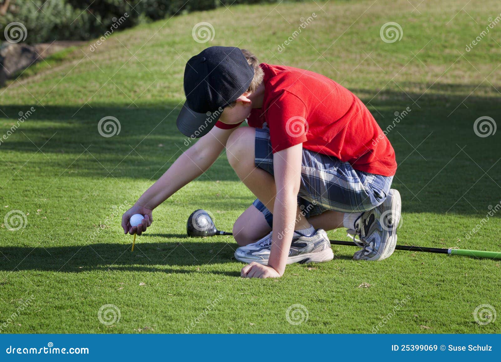 Young Golfer teeing up stock image. Image of active, grass - 25399069