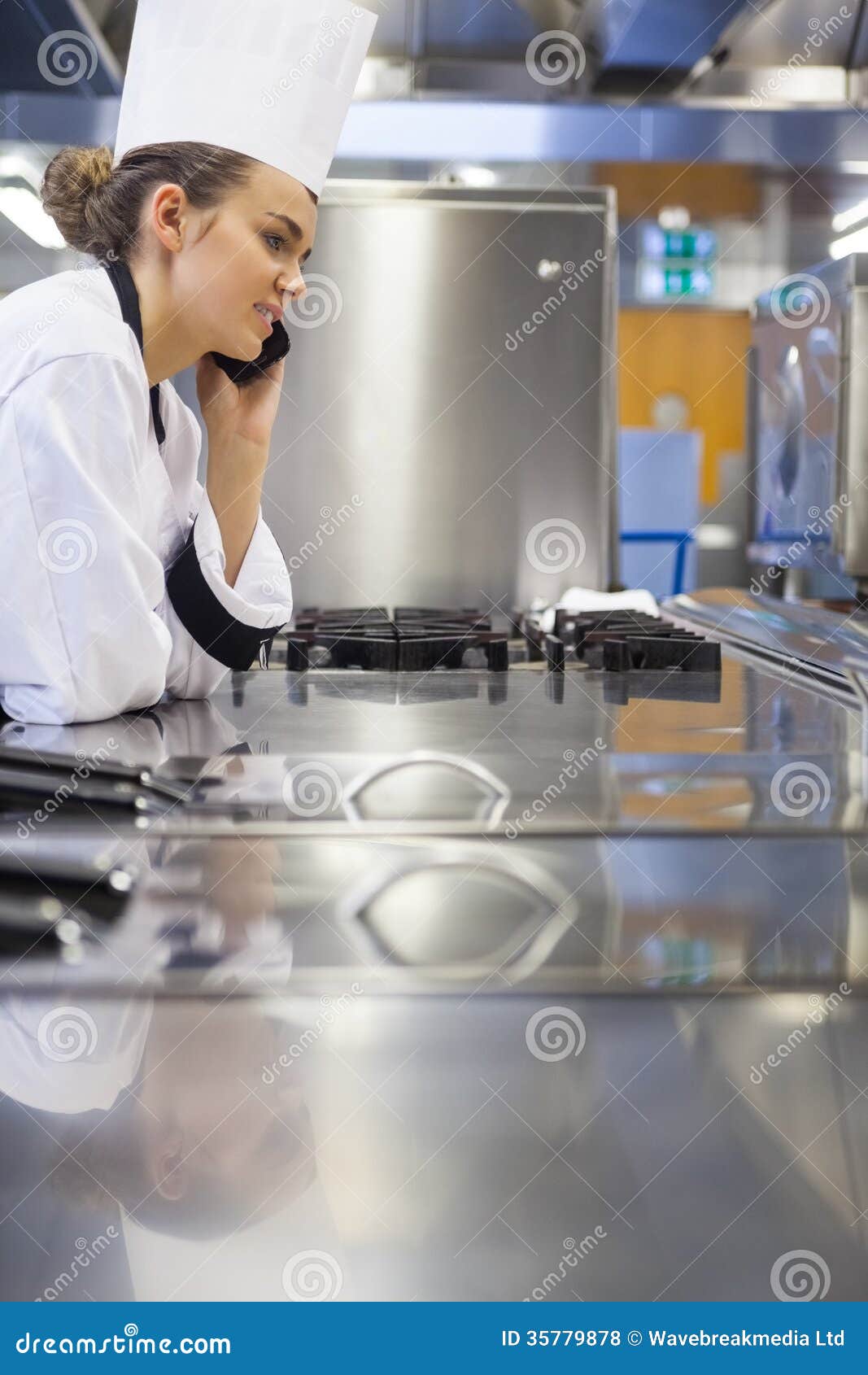 Young Gorgeous Chef Standing Next To Work Surface Phoning Stock Photo ...