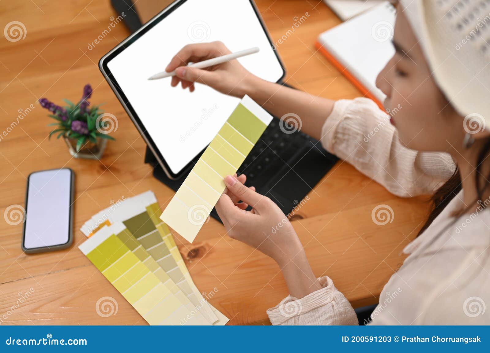 A Young Graphic Designer Working on Digital Tablet and Using Colour ...