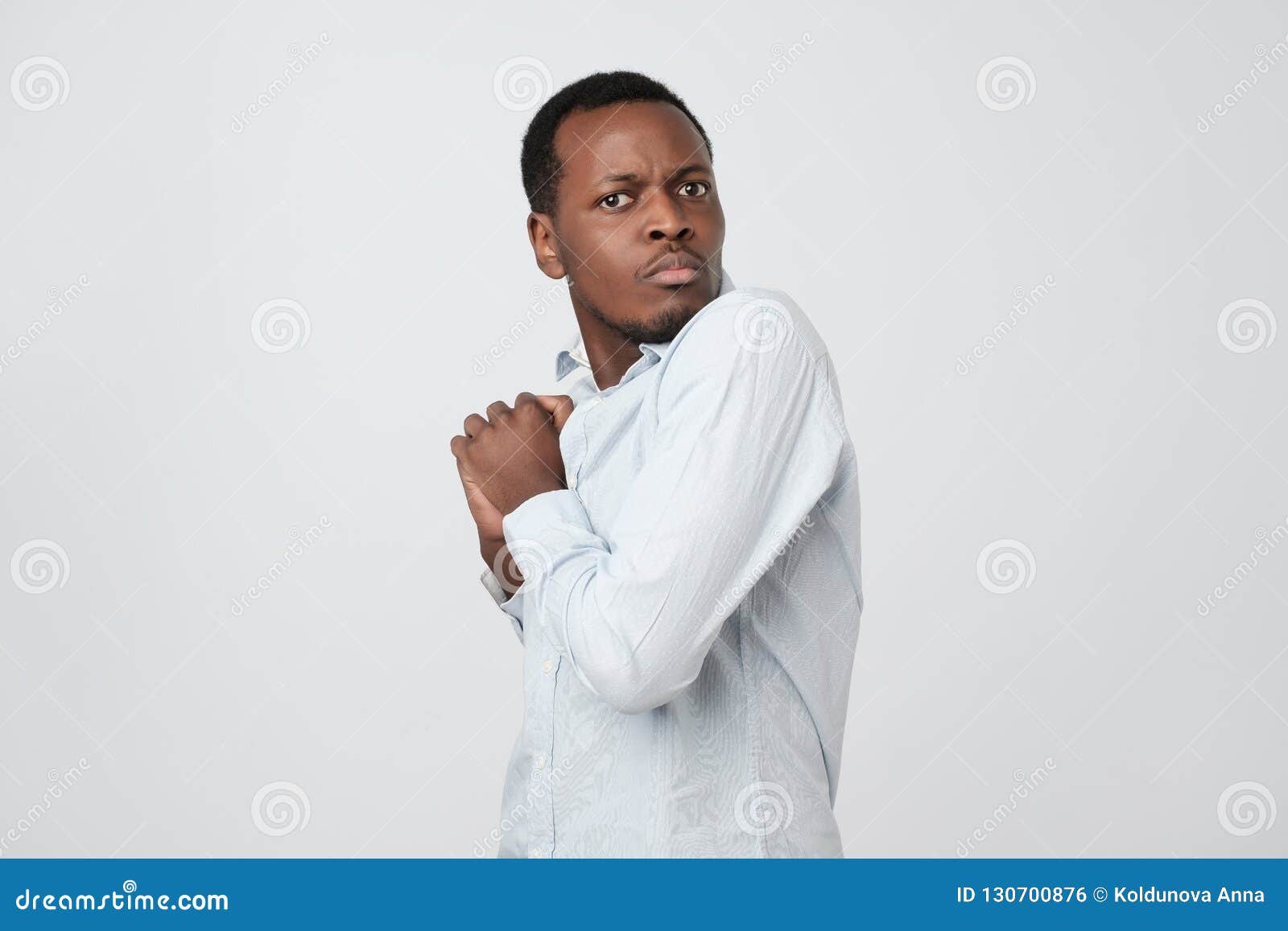 A Young Greedy Man Hides Something in His Hands and Looks Warily ...