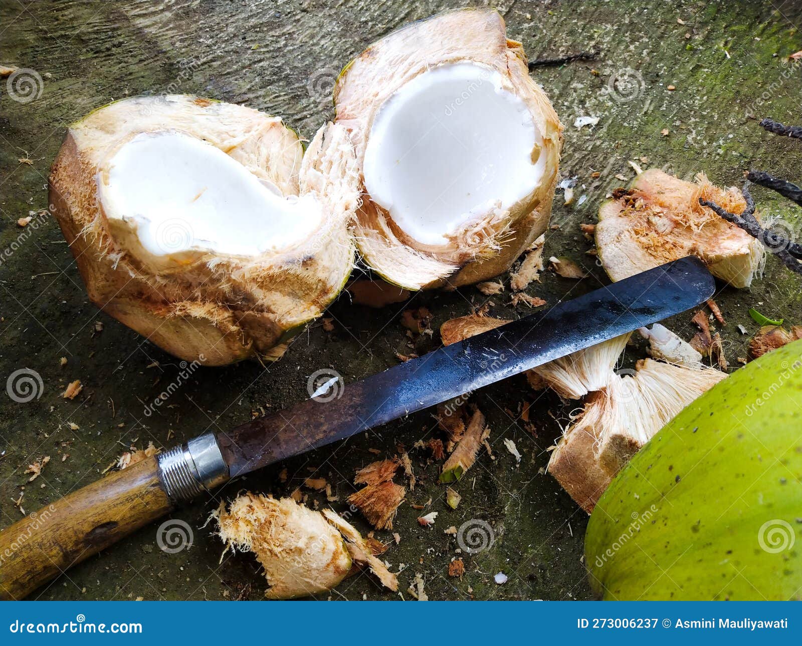 A Young Green Coconut that Has Been Split Open with a Machete Next To ...