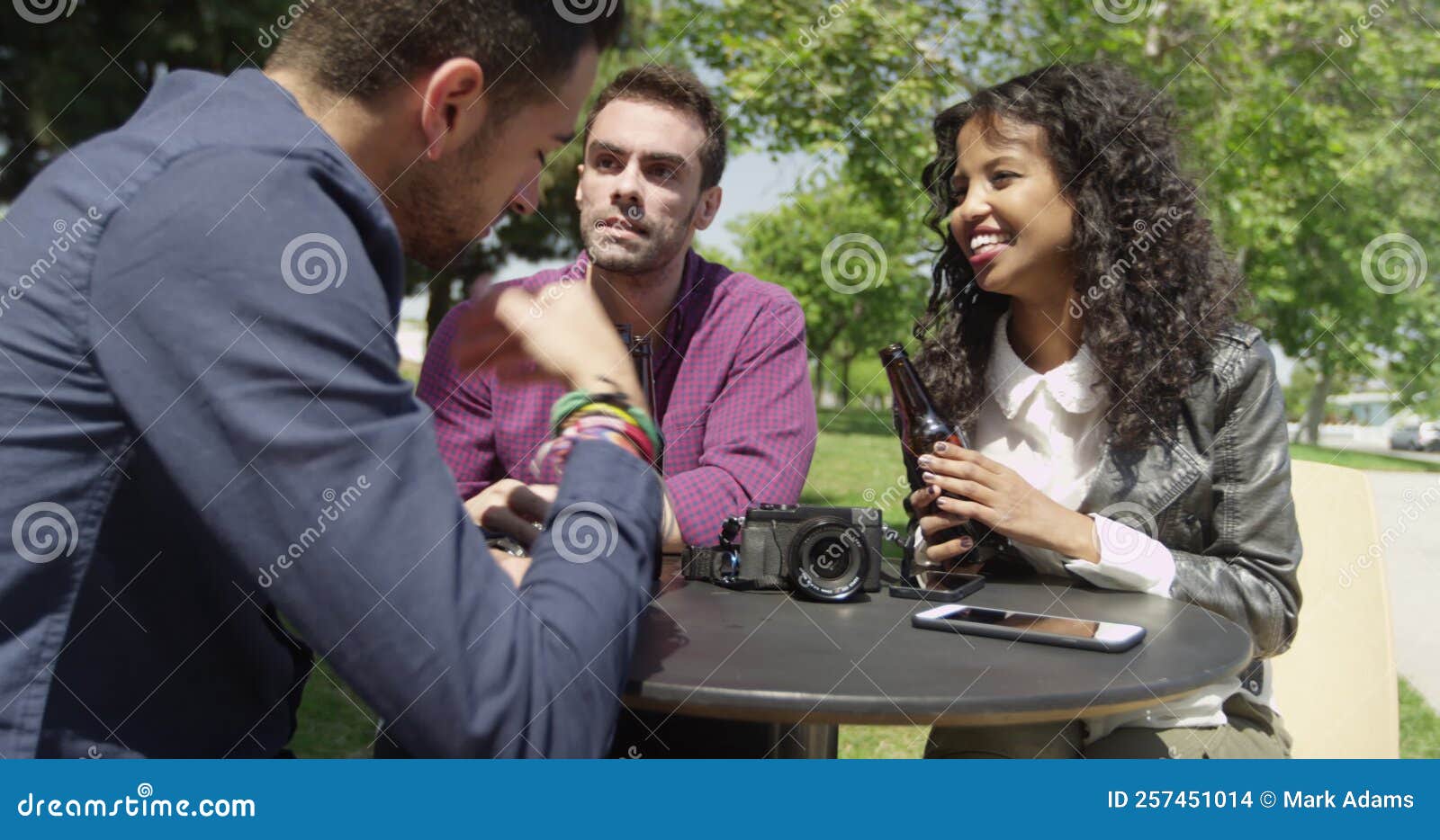 Young Group of Friends Talking Together with Drinks Outdoors Stock ...