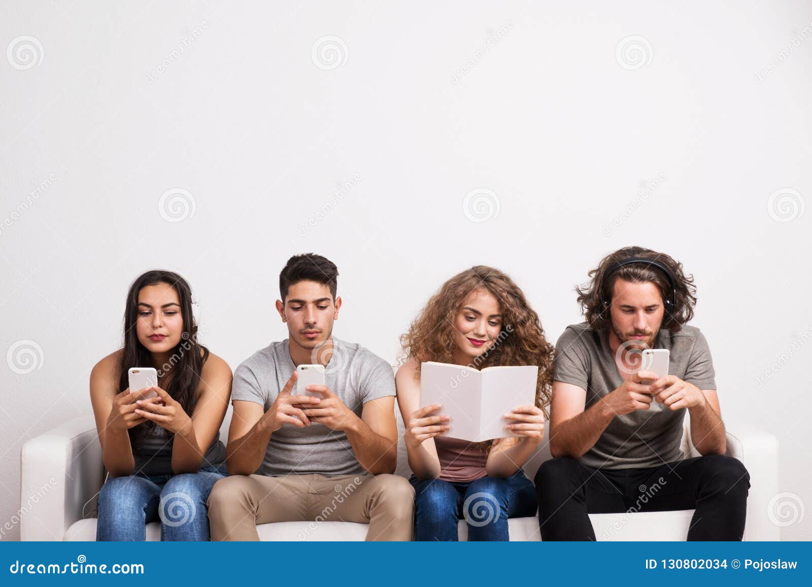 Young Group of Friends Using Modern Technology and Traditional Source ...