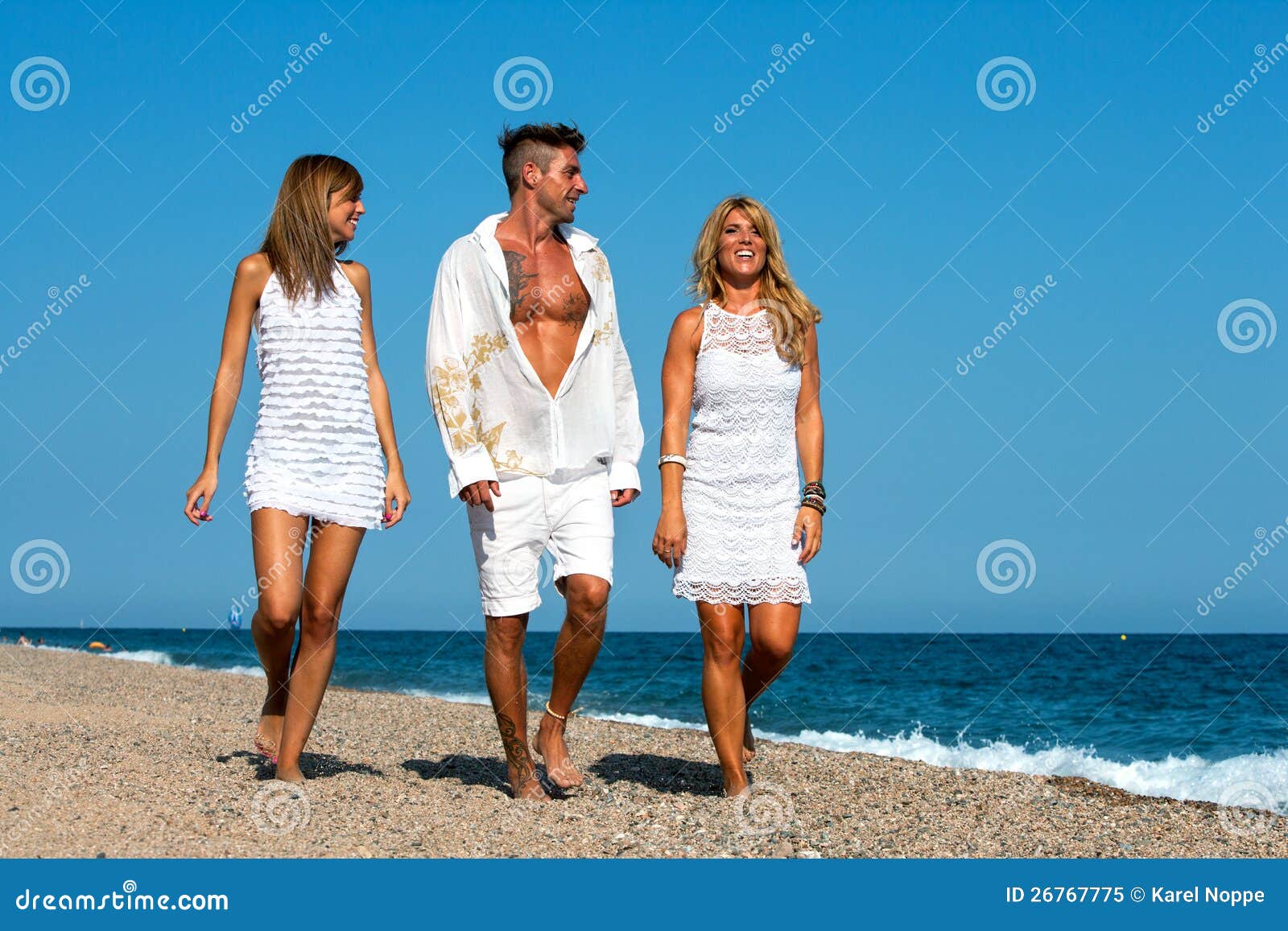 Young Group of Friends Wandering Along Beach. Stock Image - Image of ...