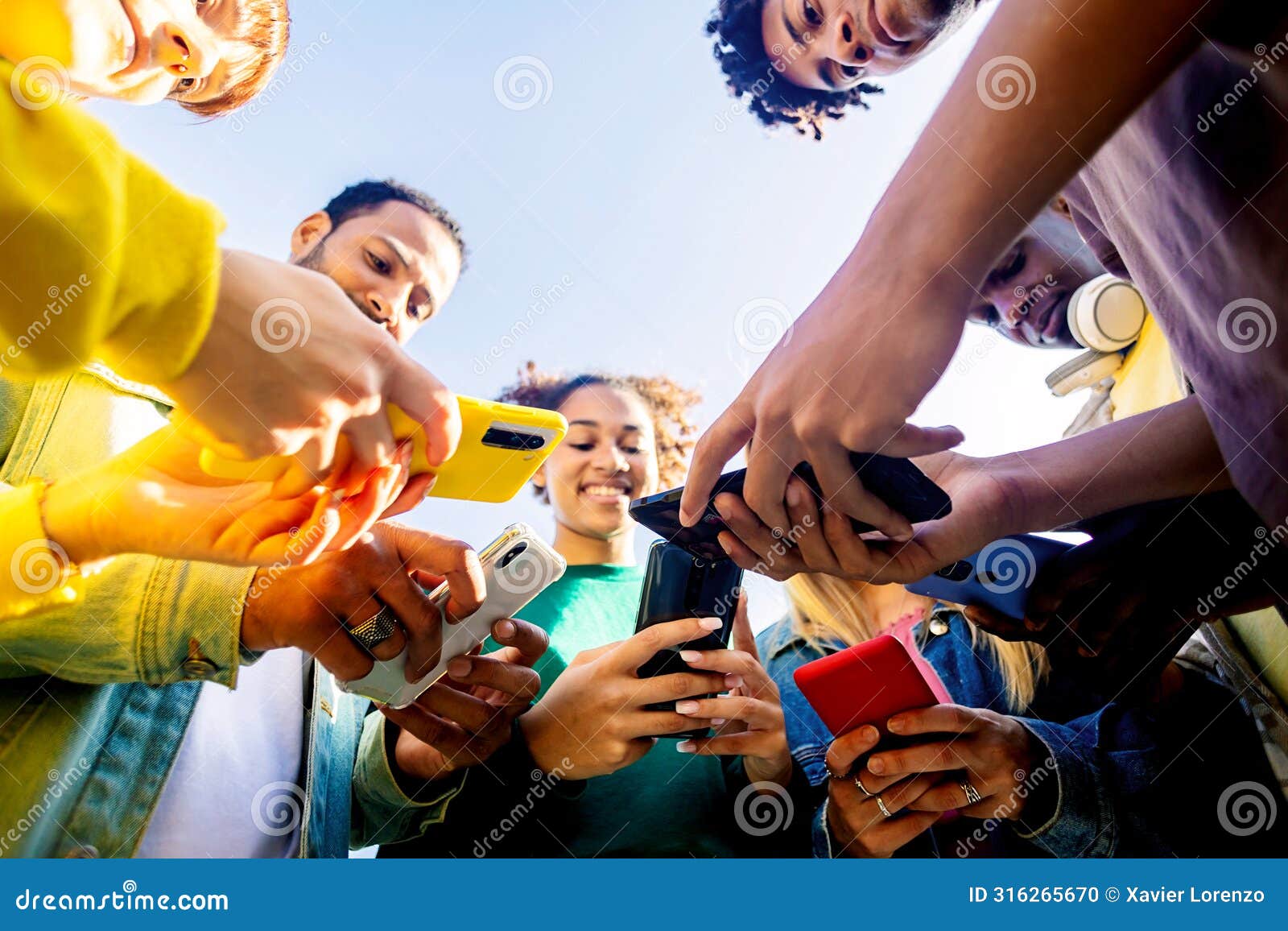 Young Group of People Using Mobile Phone Outdoors. Stock Photo - Image ...