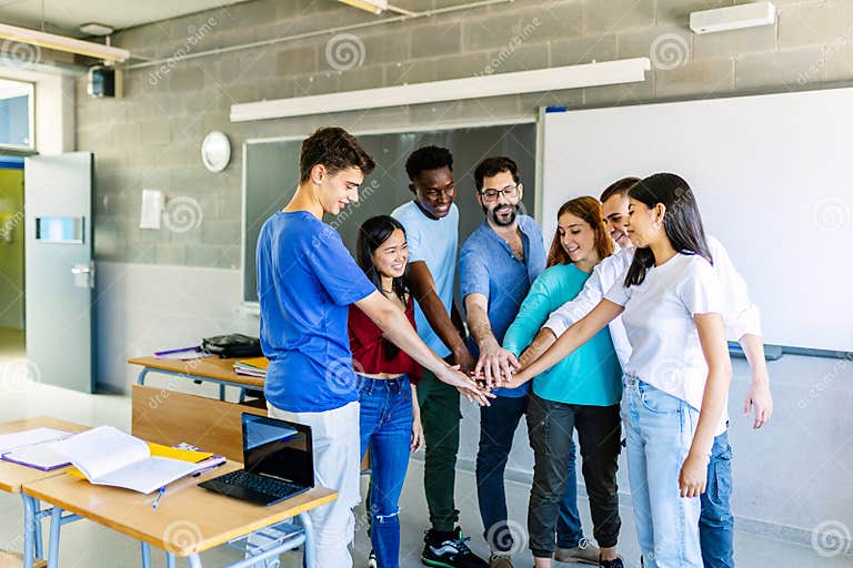 Young Group of Student Classmates Stacking Hands with Teacher in ...