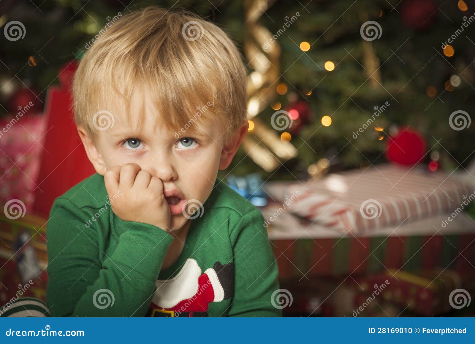 Young Grumpy Boy Sitting Near Christmas Tree Stock Photo - Image of ...
