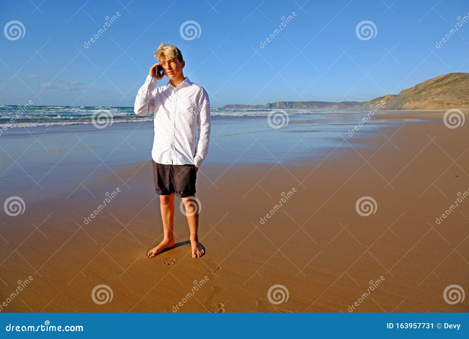 Young Guy at the Beach Making a Phone Call Stock Image - Image of phone ...