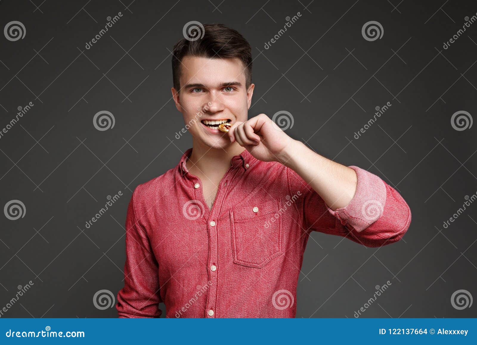 A Young Guy Bites a Coin Bitcoin with His Teeth, Checking for Au Stock ...