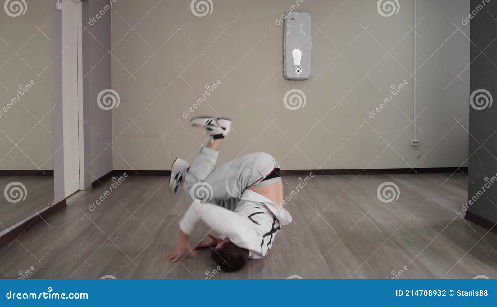 Young Guy Breakdancer Dances Hip Hop on Floor in Studio. Handsome Guy ...