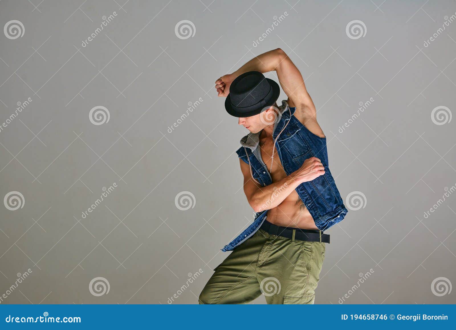 Young Guy Breakdancer In Hat Dancing Hip-hop In Studio Isolated On Gray ...