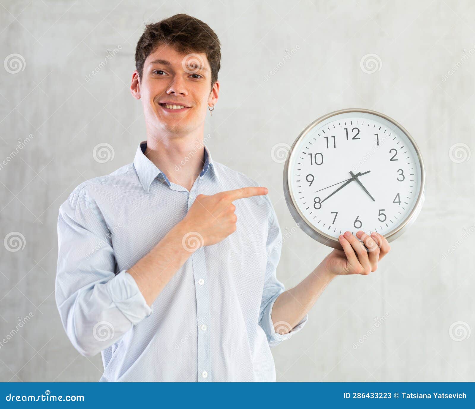 Young Guy Posing with Clock in Studio Stock Image - Image of deadline ...
