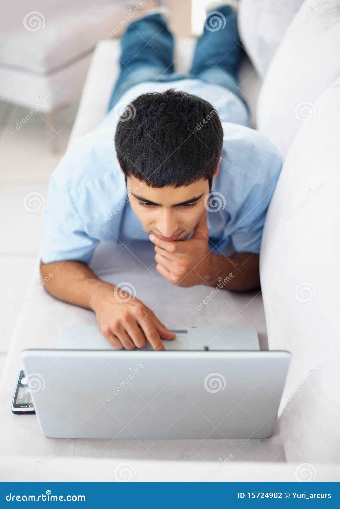 Young Guy Checking Something on a Laptop at Home Stock Photo - Image of ...