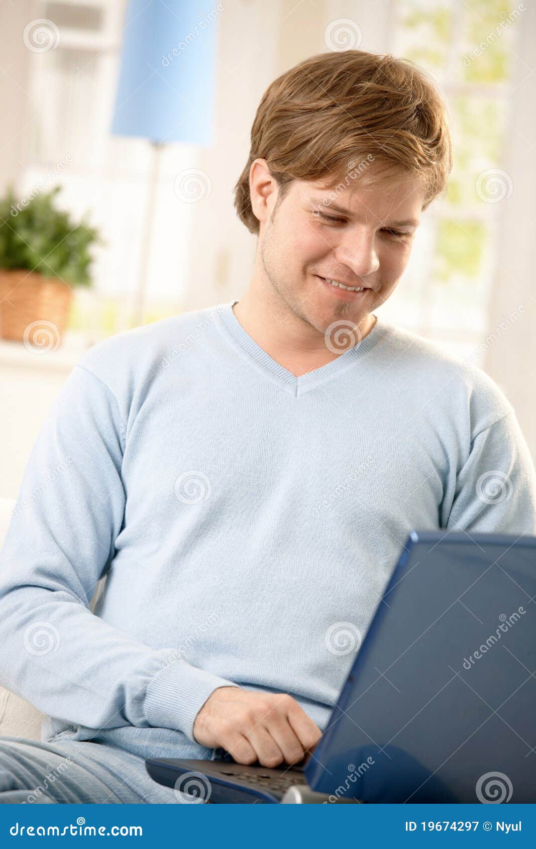Young guy with computer stock image. Image of look, blond - 19674297