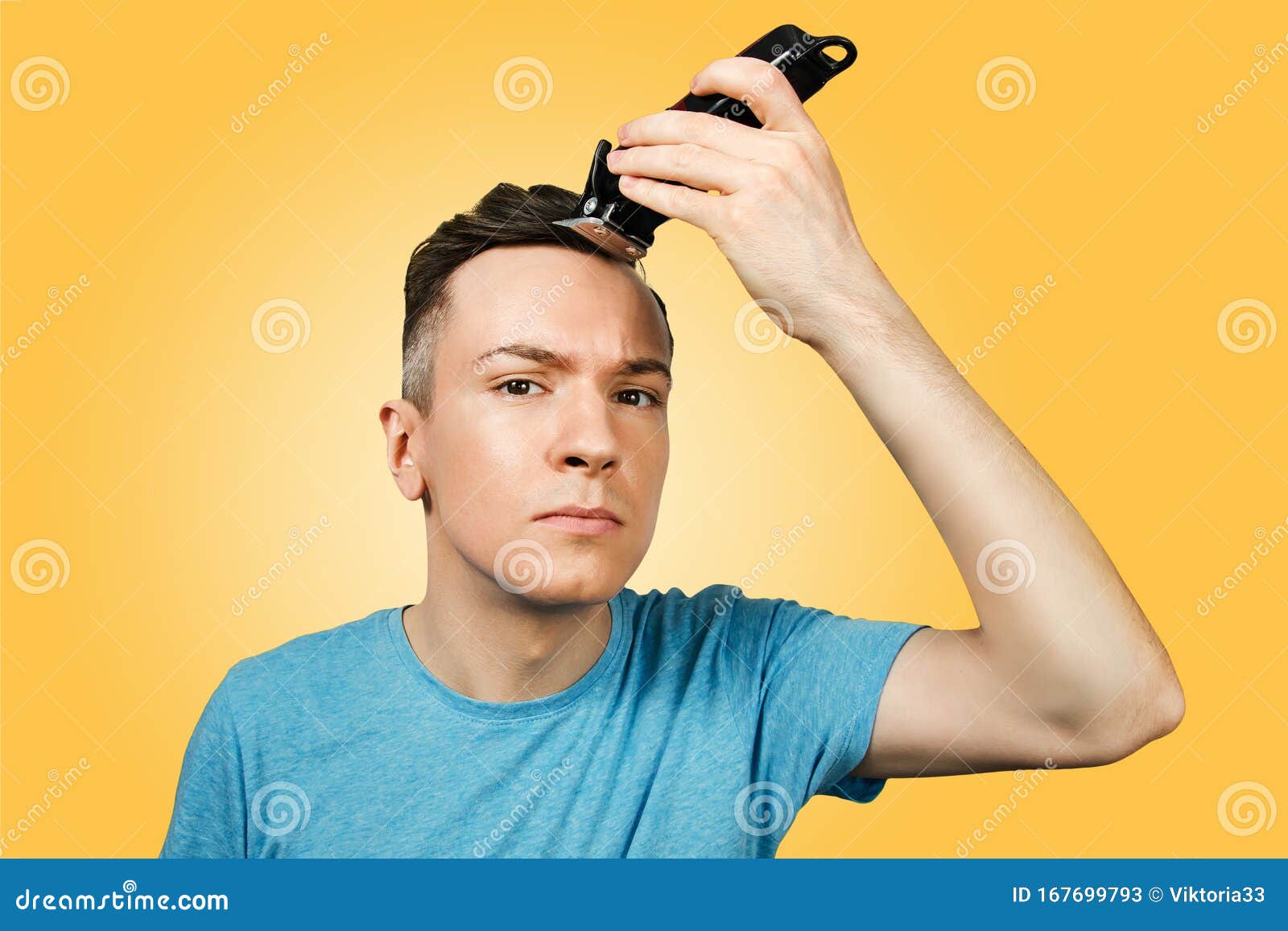 Young Guy Cuts Himself with a Clipper on a Light Background Stock Image ...