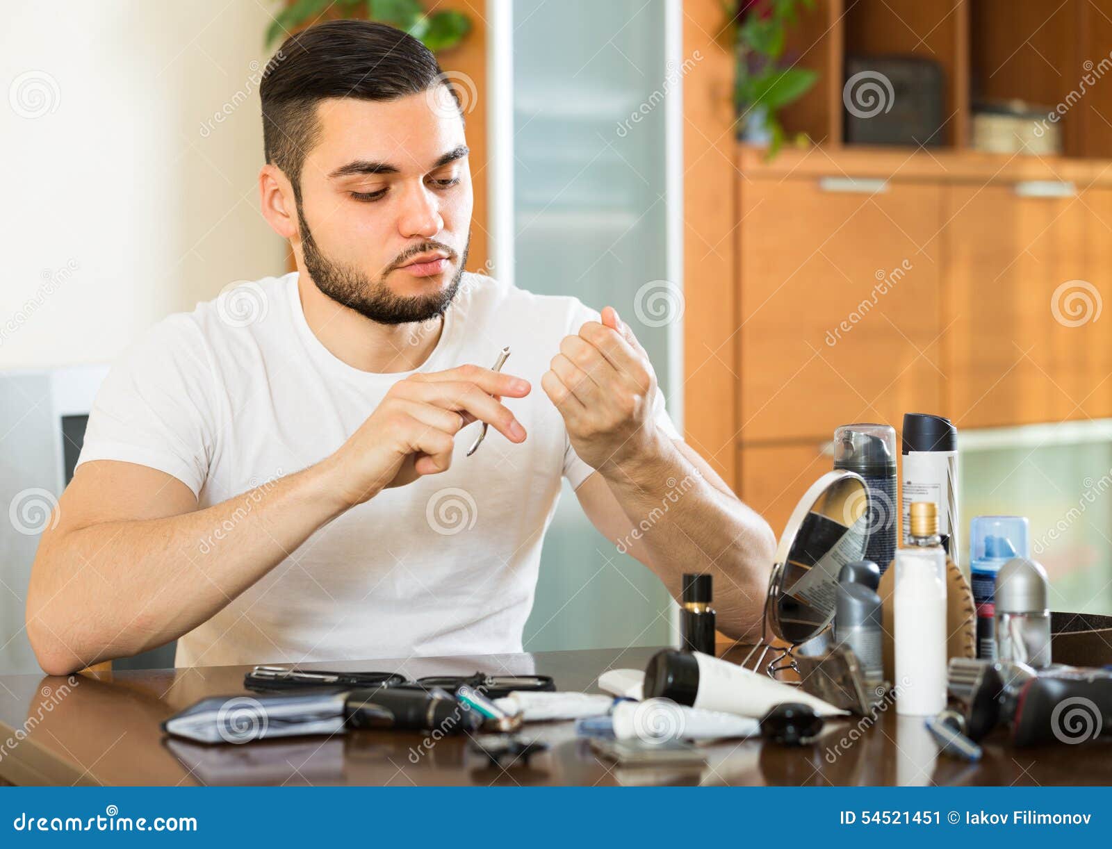 Young guy cutting nails stock image. Image of finger - 54521451