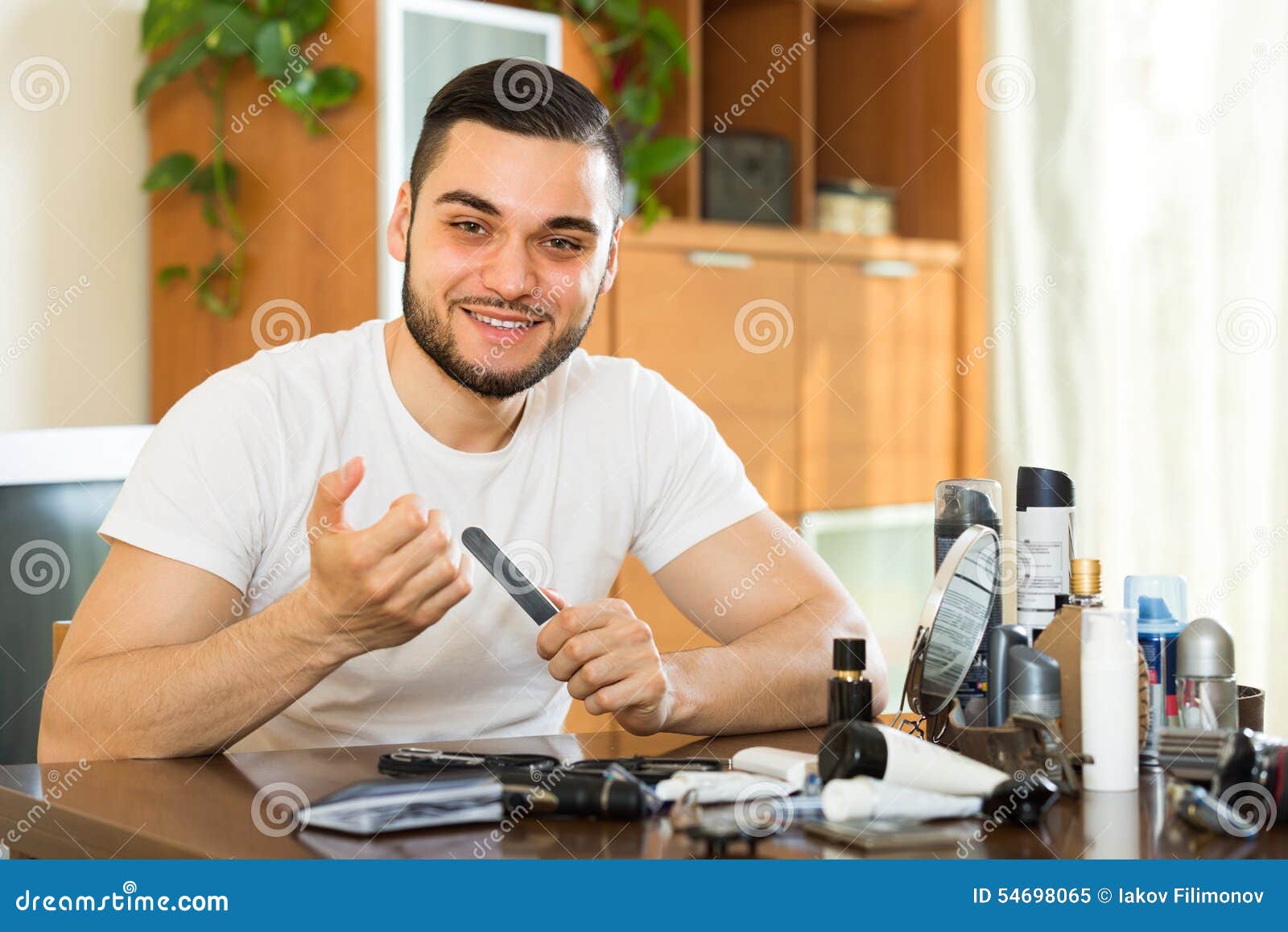 Young guy cutting nails stock image. Image of casual - 54698065