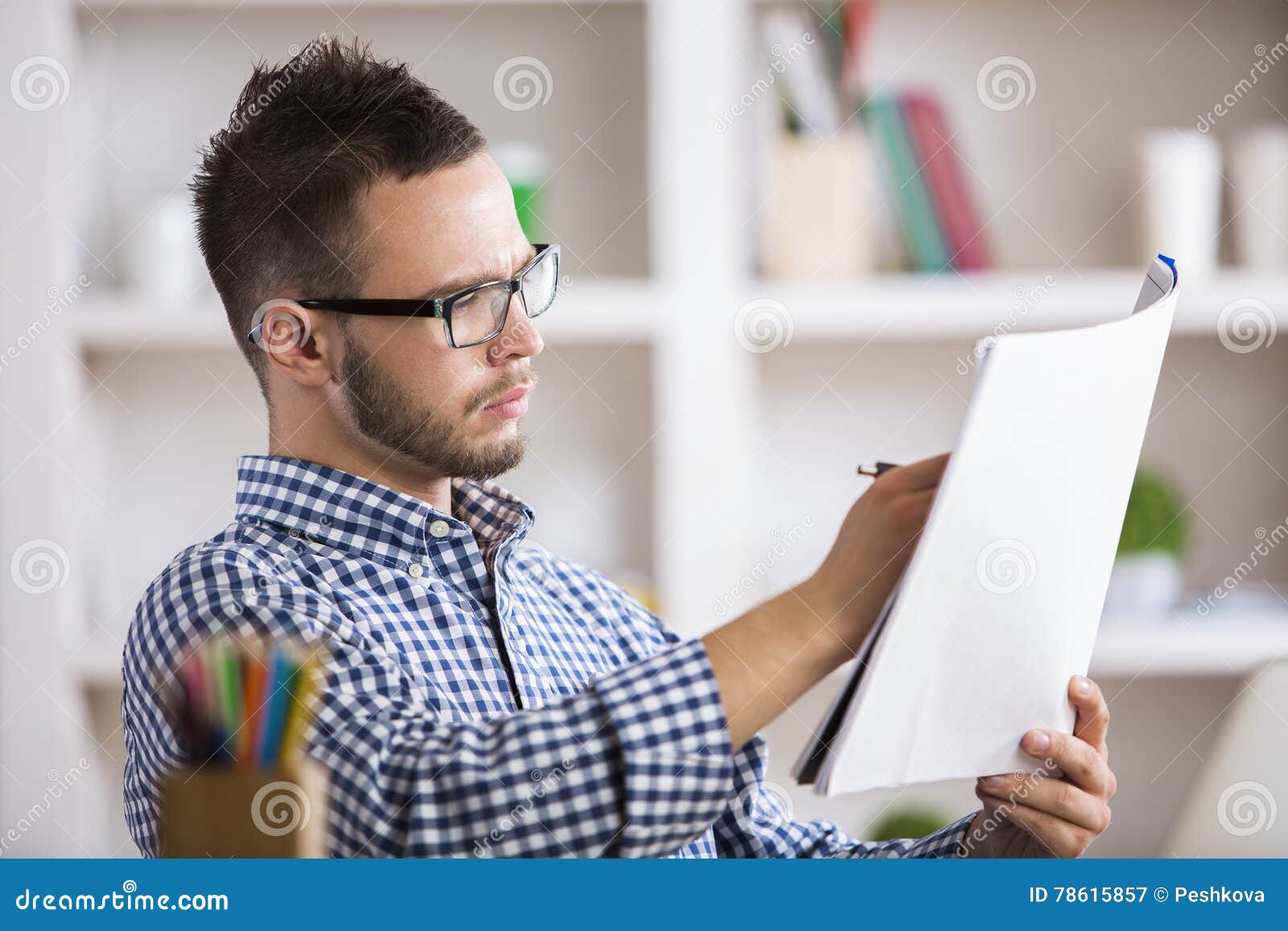 Young guy doing paperwork stock image. Image of business - 78615857
