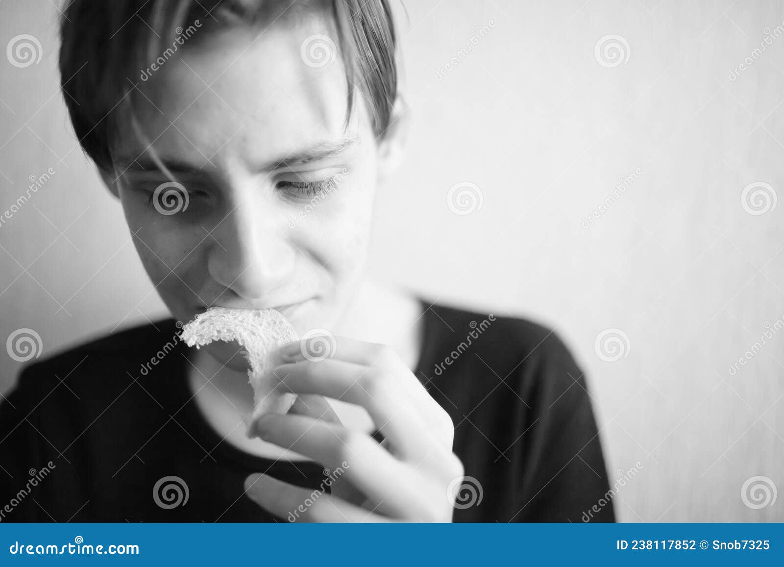 Young guy eating bread stock photo. Image of pandemic - 238117852