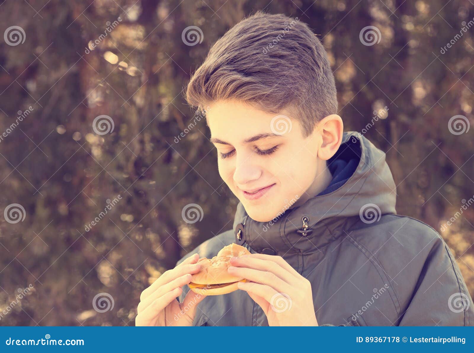 Young Guy Eating a Cheeseburger Stock Photo - Image of fatty ...
