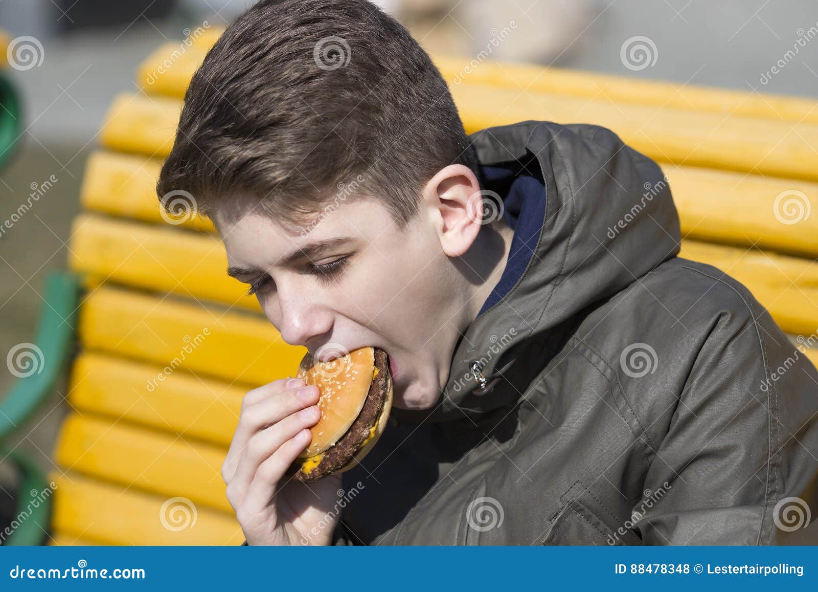 Young Guy Eating a Cheeseburger on the Nature Stock Photo - Image of ...