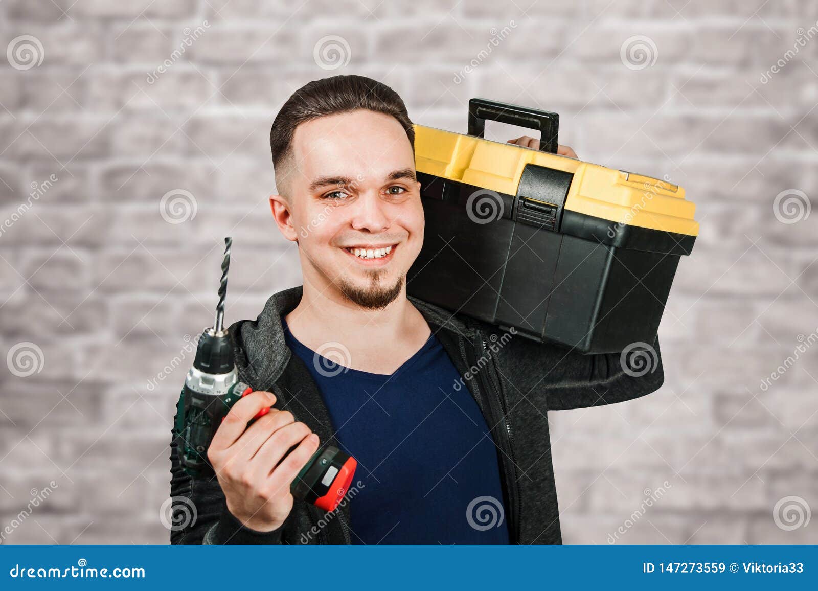 Young Guy Holding Toolbox and Screwdriver on Brick Wall Background ...