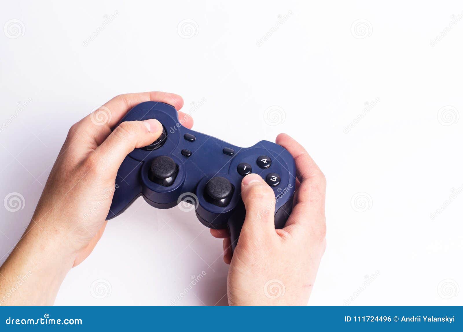 A Young Guy Holds a Joystick and Plays Computer Games on a White Stock ...