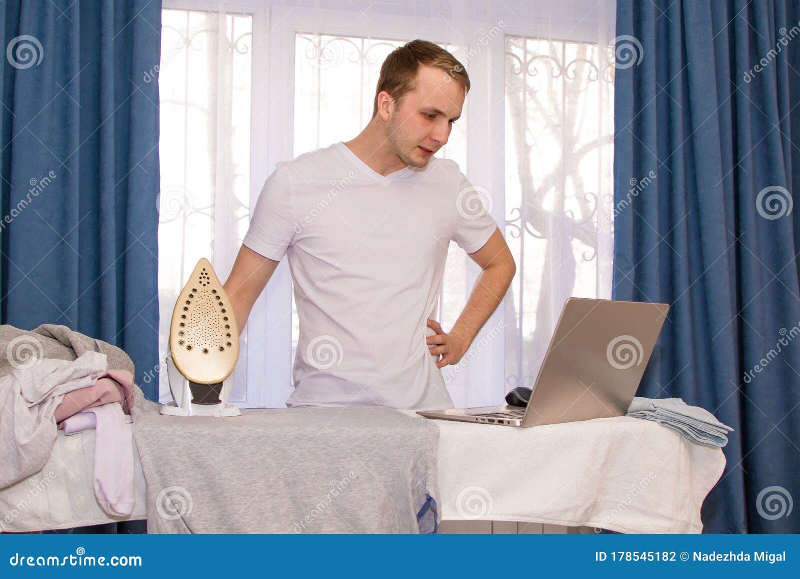 A Young Guy at Home on Self-isolation Works Remotely and is Engaged in ...