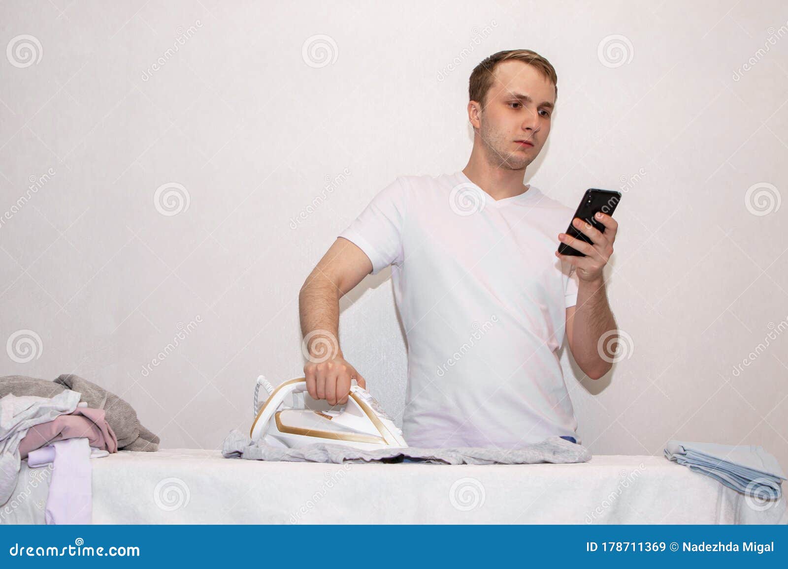 A Young Guy at Home on Self-isolation Works Remotely and is Engaged in ...