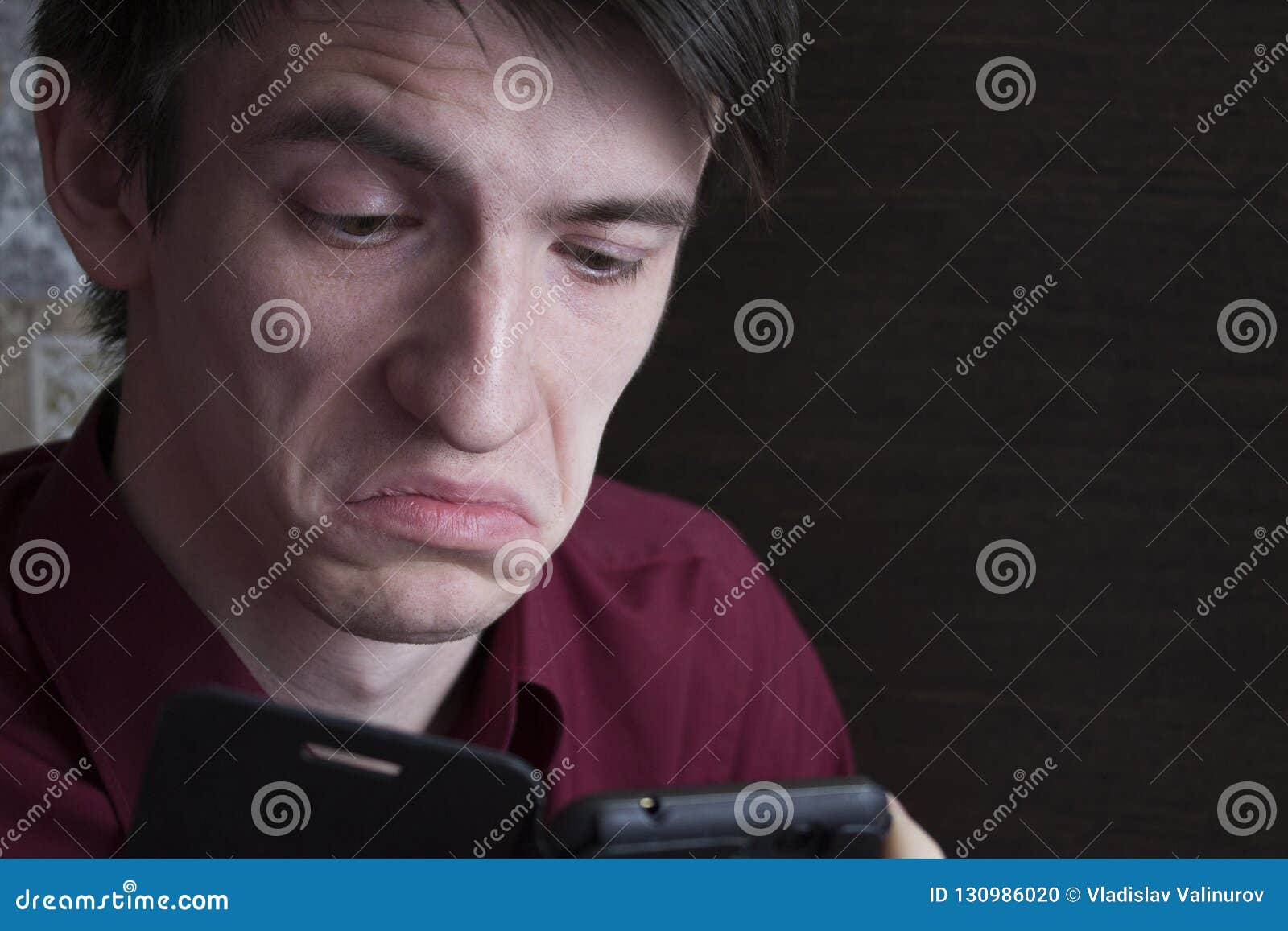 Young Guy Looking into Smartphone, Sad Face Stock Photo - Image of ...