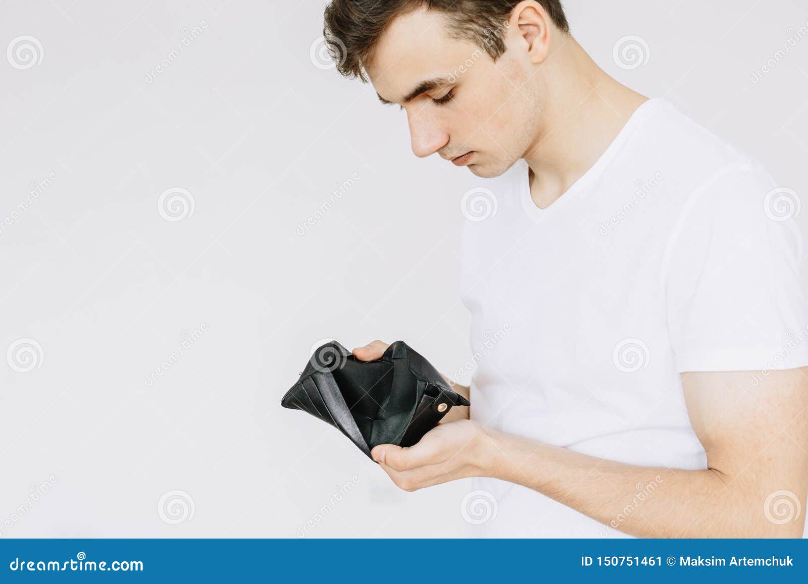 A Young Guy Looks in an Empty Wallet. Isolated White Background Stock ...