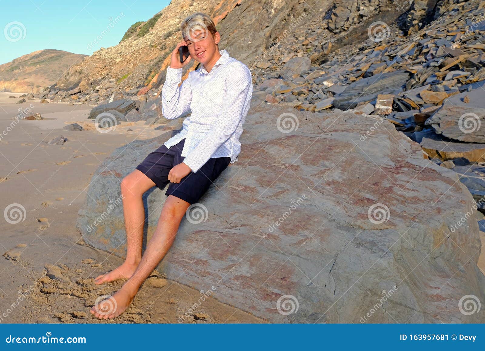 Young Guy Making a Phone Call at the Beach Stock Image - Image of male ...