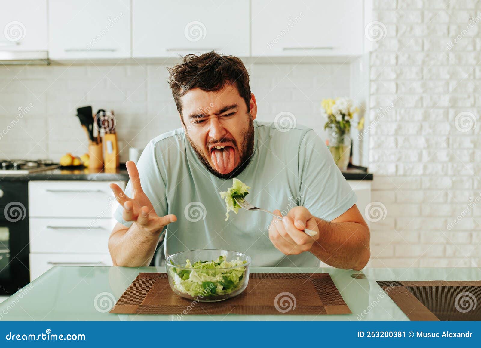 Young Guy Man Screams in Horror Holding Fork with Salad in Hand and ... Young Guy Man Screams in Horror Holding Fork with Salad in Hand and ...