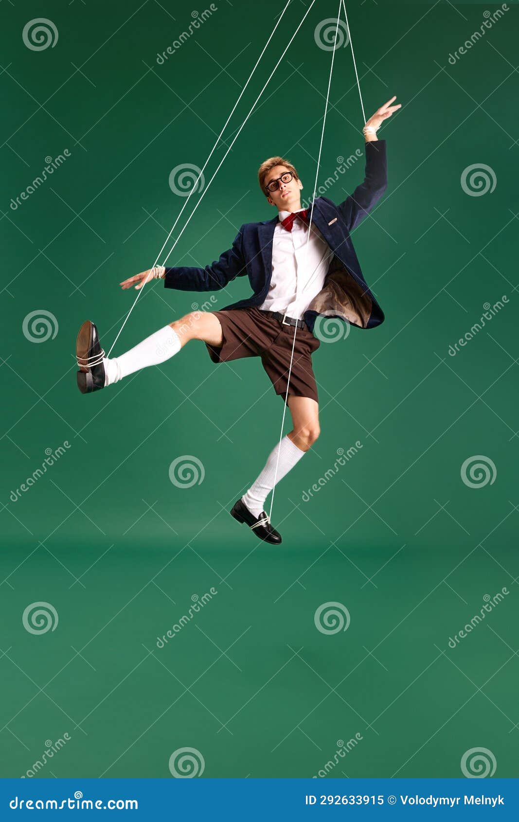 Young Guy, Marionette on String in Motion Against Green Studio ...