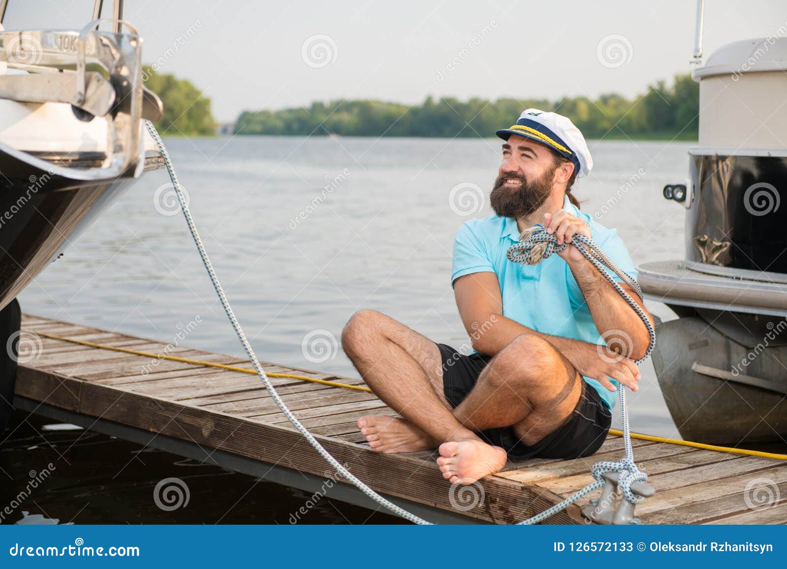 A Young Guy Moored His Yacht while Sitting on the Pier Stock Image ...