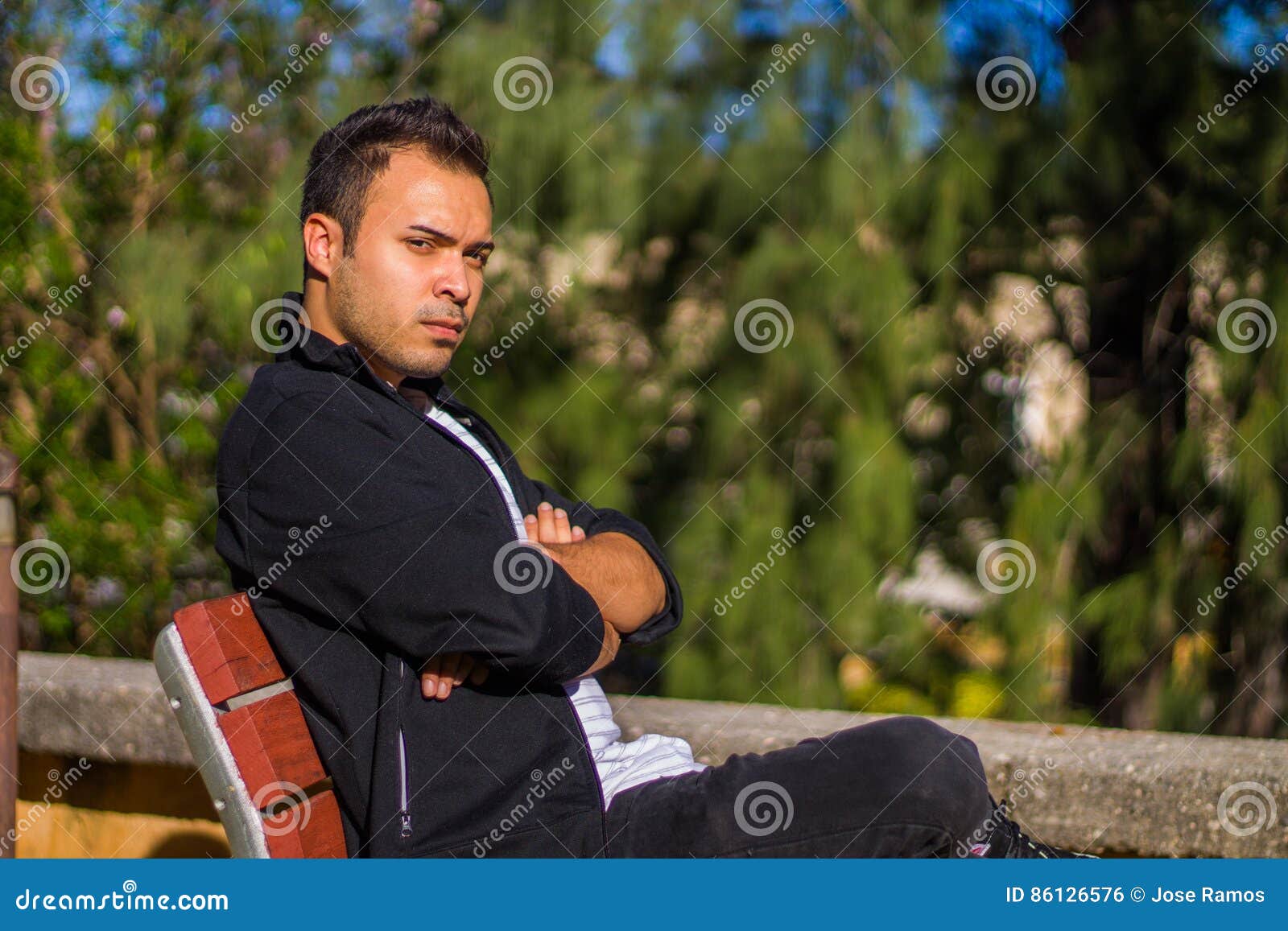 Young guy on a park bench stock photo. Image of herbal - 86126576