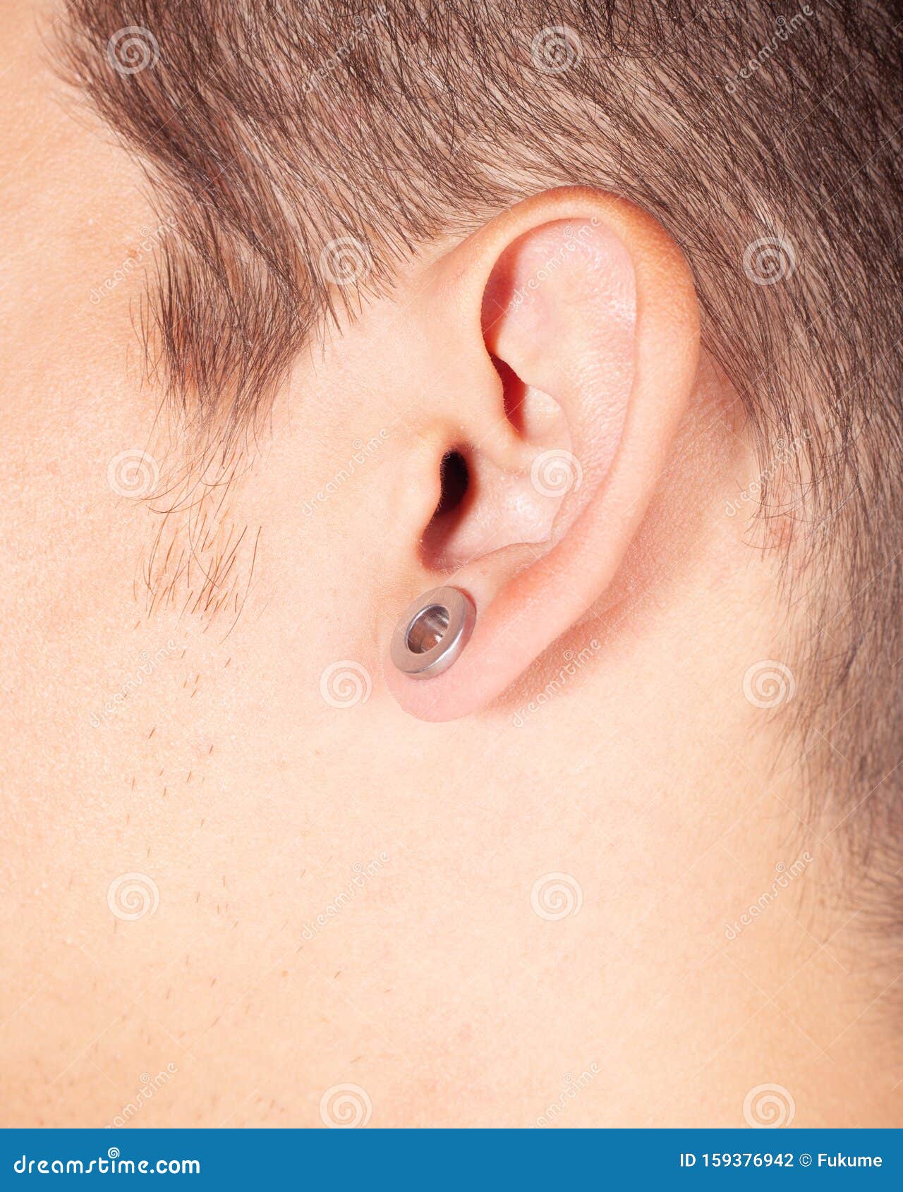 Young Guy with Piercings in His Ear Stock Photo - Image of beard, body ...